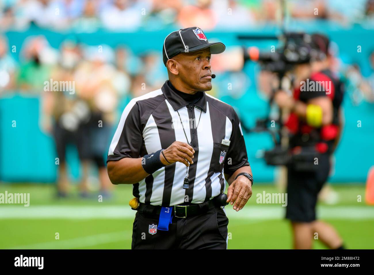 NFL line judge Carl Johnson stands on the field during an NFL football ...