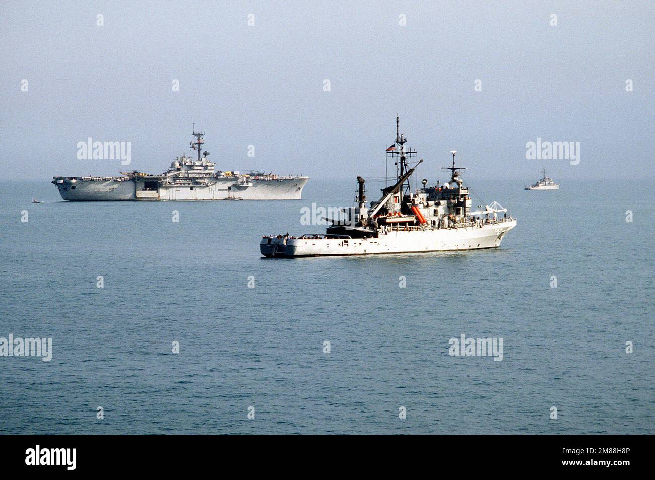 The salvage and rescue ship USS BEAUFORT (ATS-2), foreground, the ...