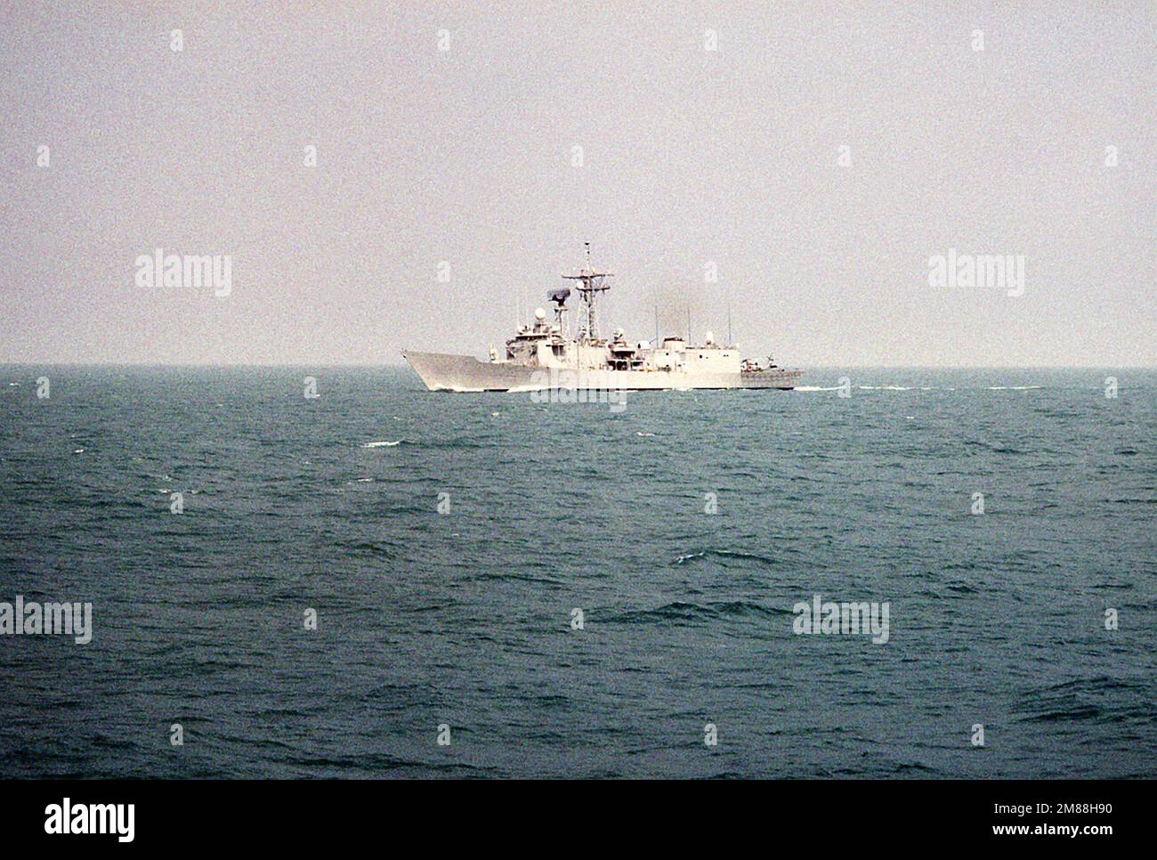 A port view of a Perry-class guided missile frigate underway on patrol ...