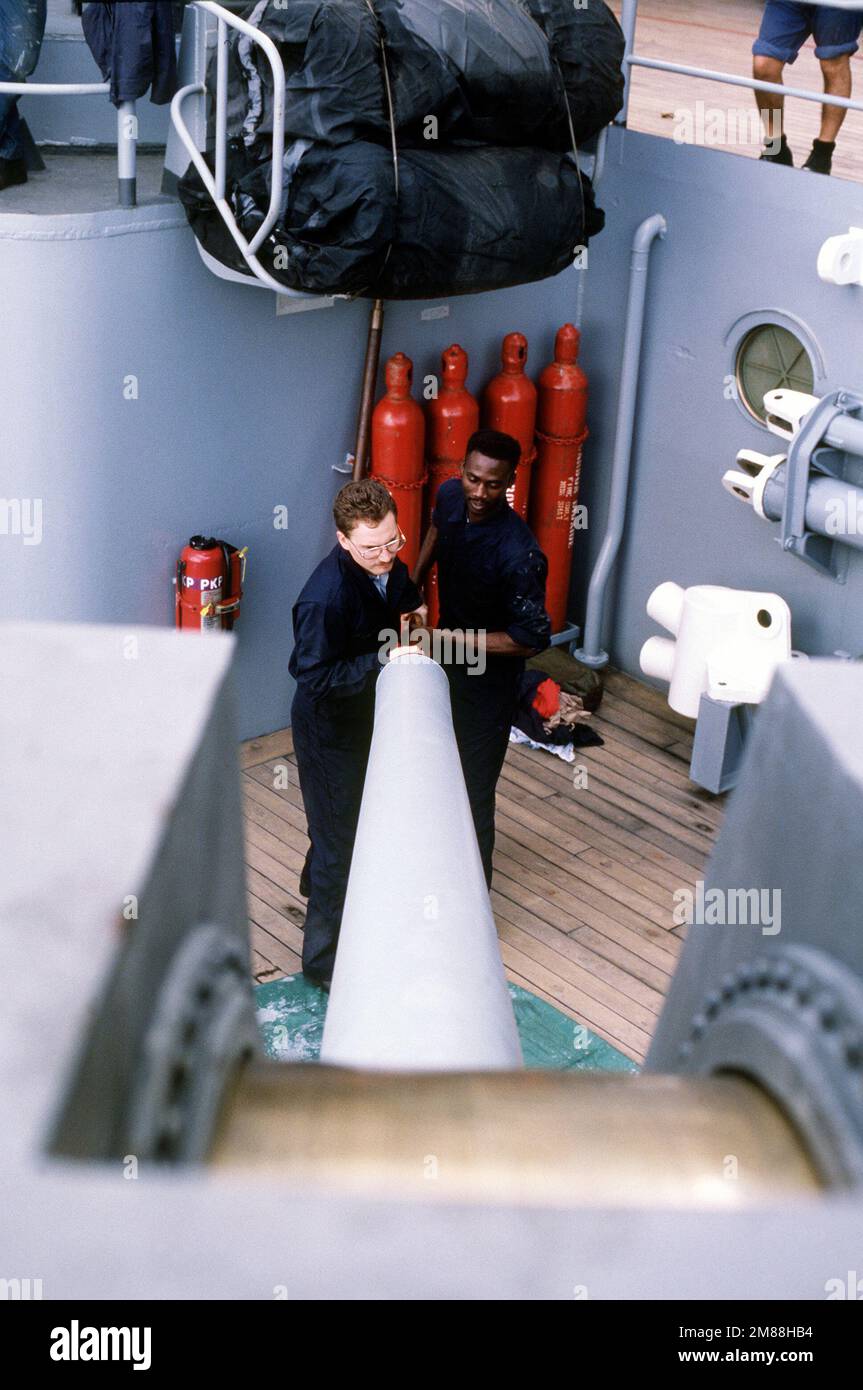 GUNNER's mates clean the barrel of a Mark 28 5-inch 38-caliber gun ...