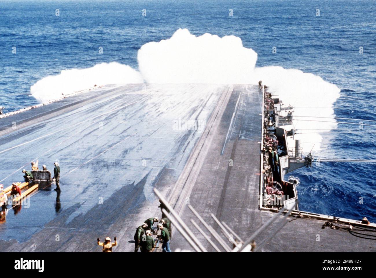The aircraft carrier USS MIDWAY (CV 41) takes white water ove its bow ...