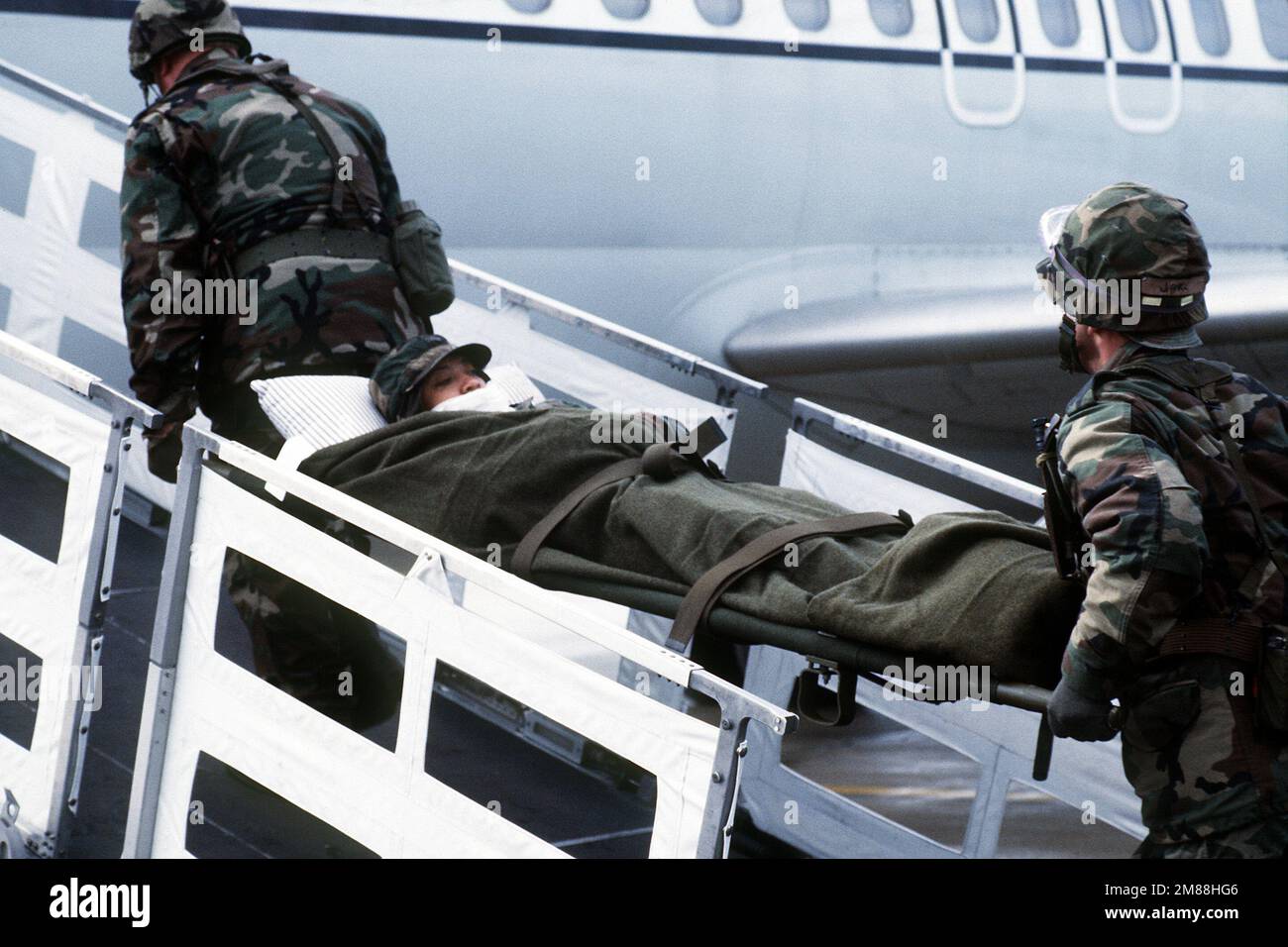 A patient is carried up a ramp into a C-9A Nightingale aircraft during ...
