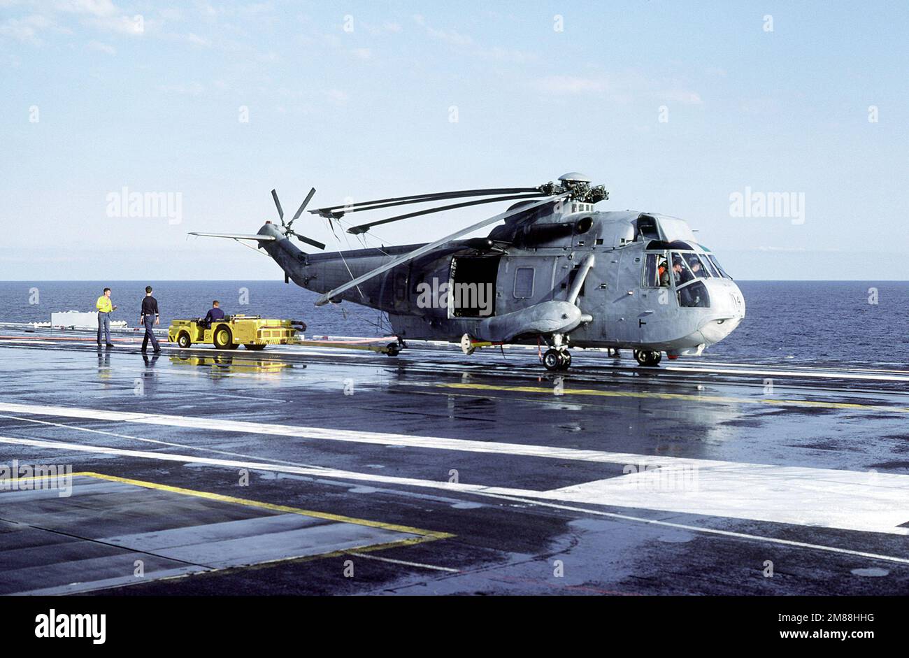 An MD-3A tow tractor is used to position a Helicopter Anti-submarine ...