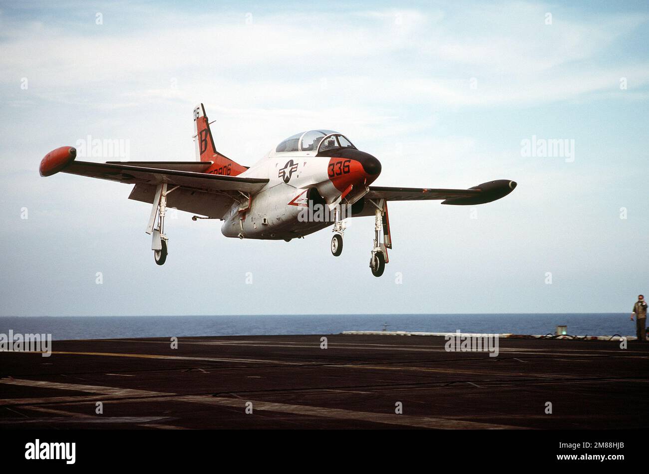A T-2C Buckeye aircraft approaches for a "touch-and-go" landing aboard ...