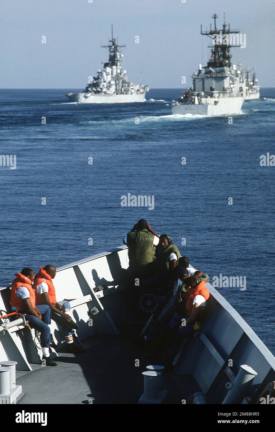 Crewmen watch for mines from the bow of the guided missile frigate USS ...