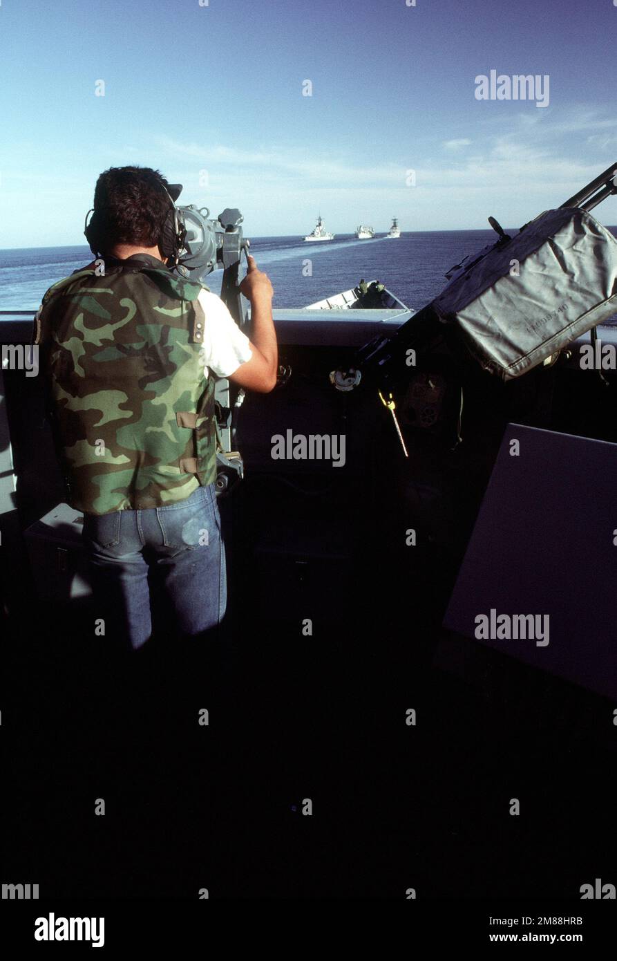 A crewman aboard the guided missile frigate USS FORD (FFG-54) observes ...