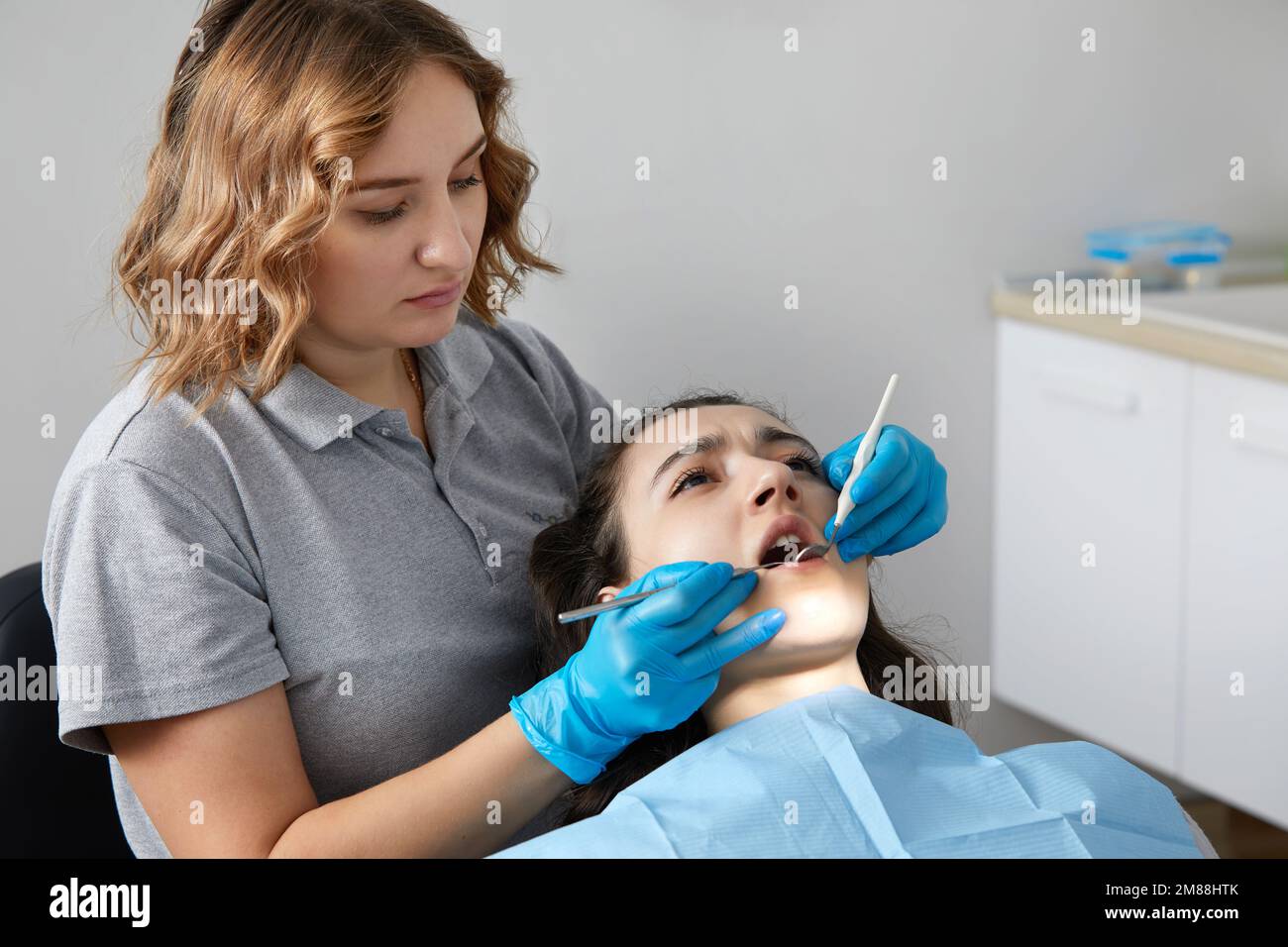 Dentist checking teeth of a female patient with dental mirror Stock ...