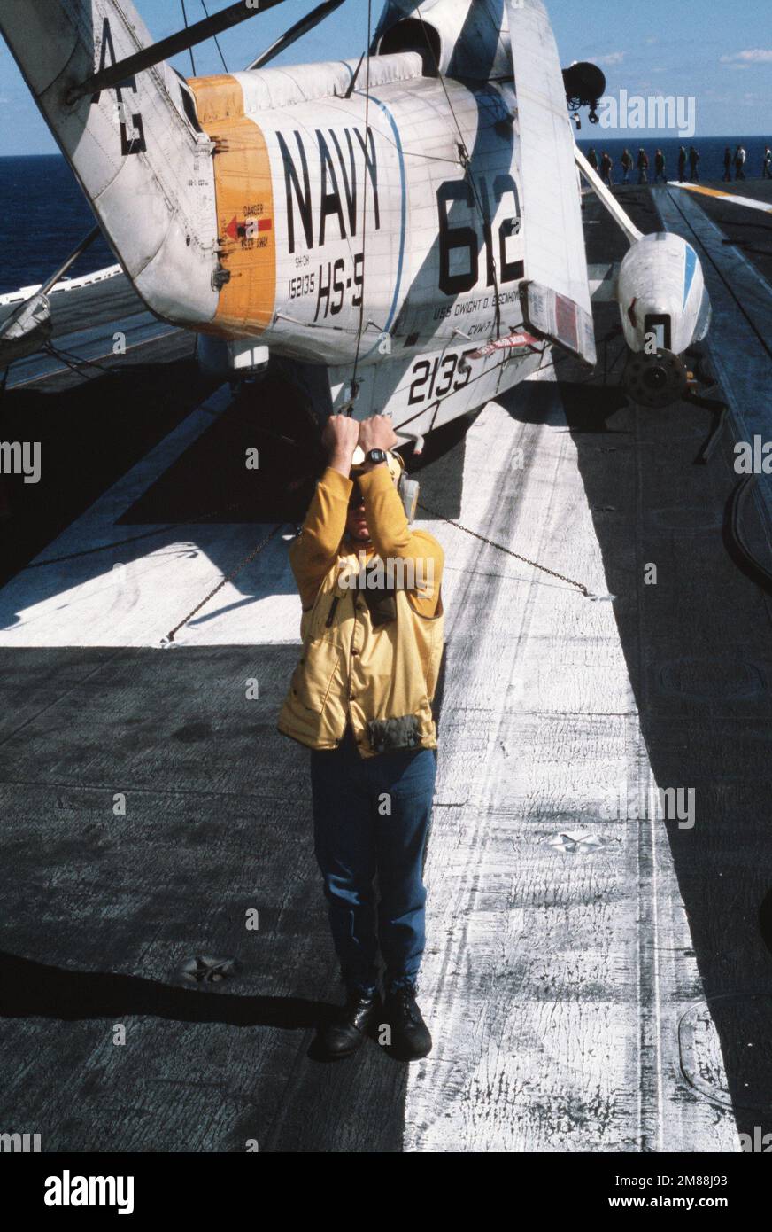 A plane director gives a helicopter pilot the "helicopter line up ...