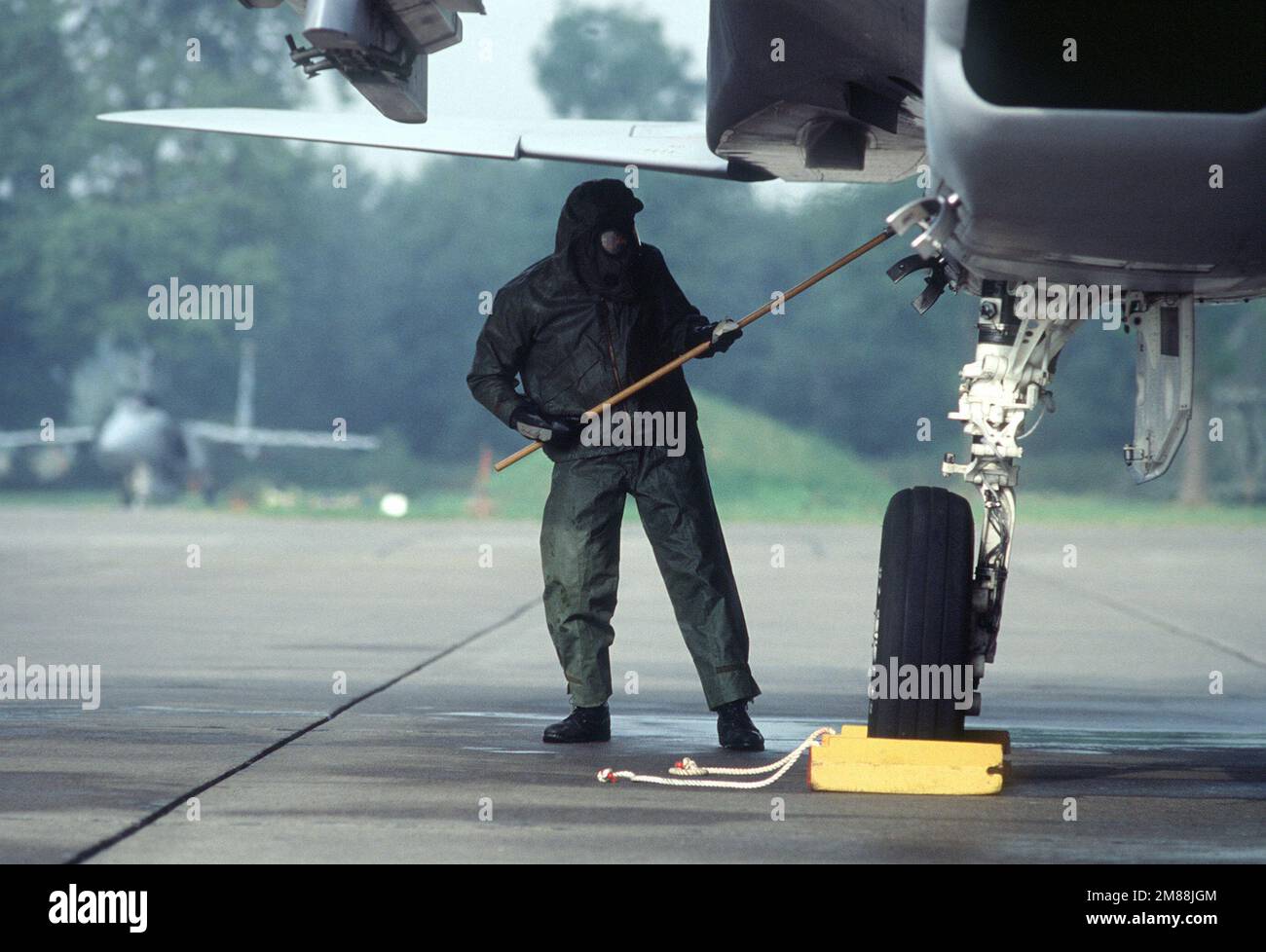 An airman from the 33rd Equipment Maintenance Squadron decontaminates a ...