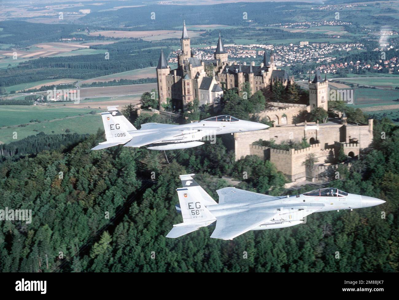 Two 58th Tactical Fighter Squadron F-15C Eagle aircraft pass ...