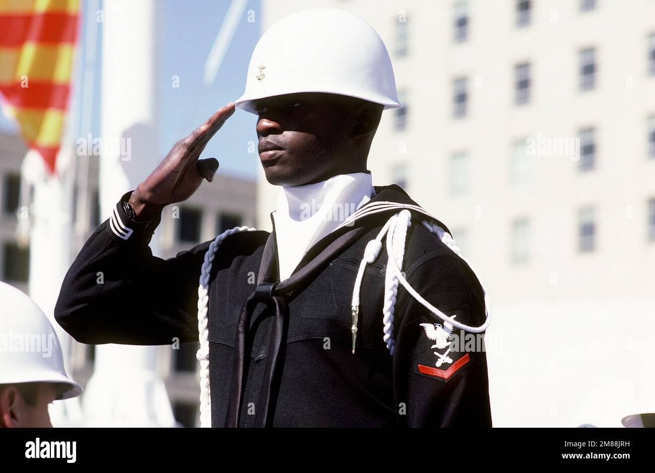 A member of the U.S. Navy ceremonial color guard salutes during the ...