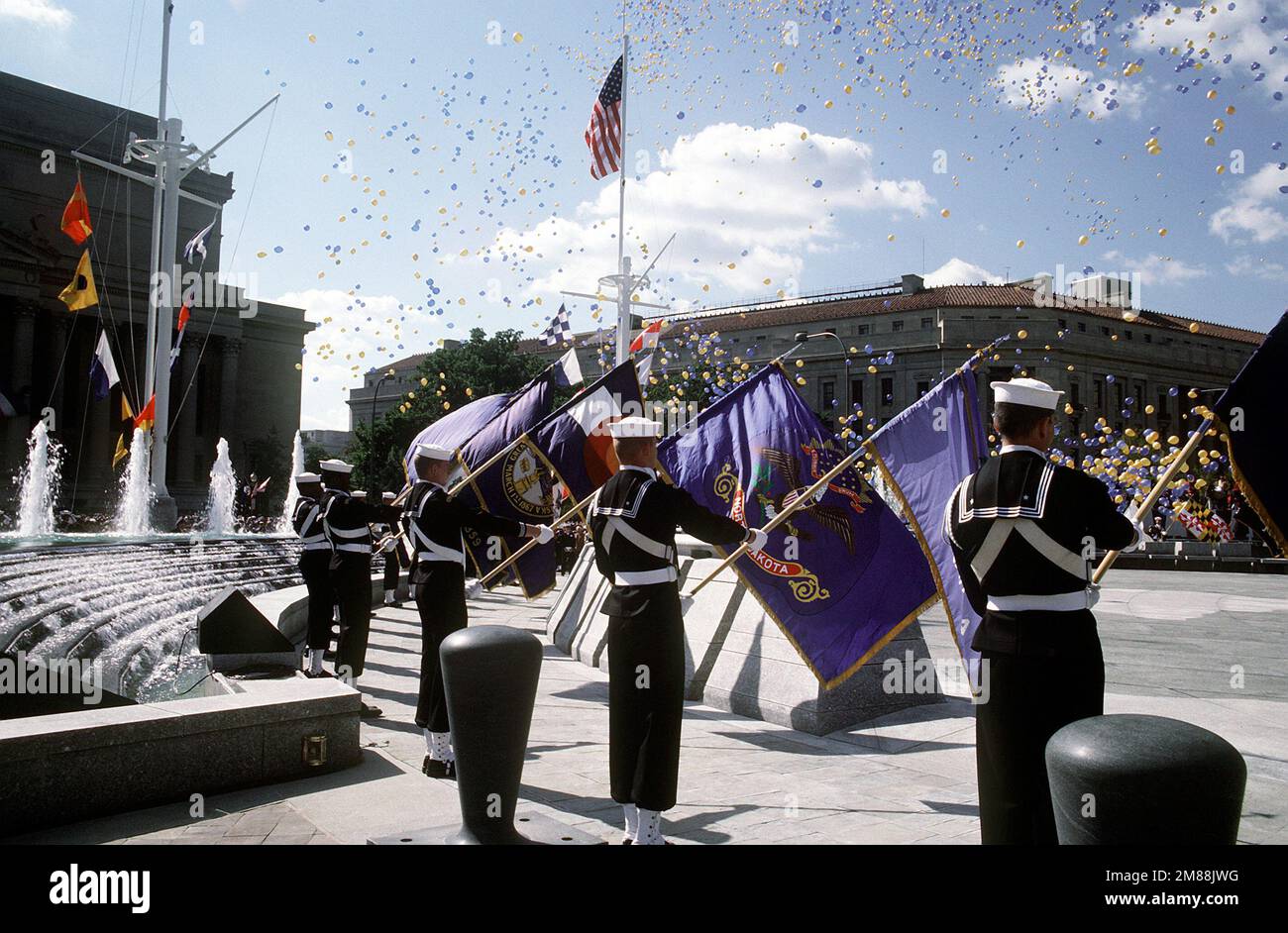 Members of the U.S. Navy ceremonial color guard present the colors as ...