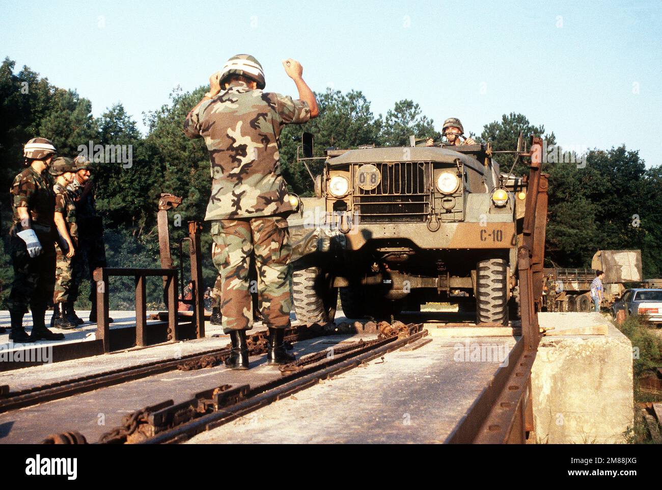 A member of the 3rd Battalion, 68th Air Defense Artillery, directs an M ...