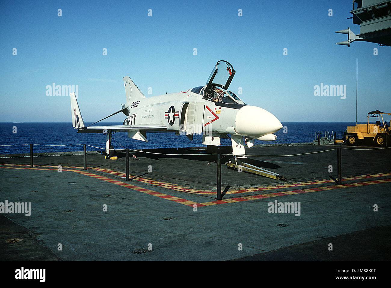 A pilot sits in the cockpit of a Naval Air Test Center F-4J Phantom II ...