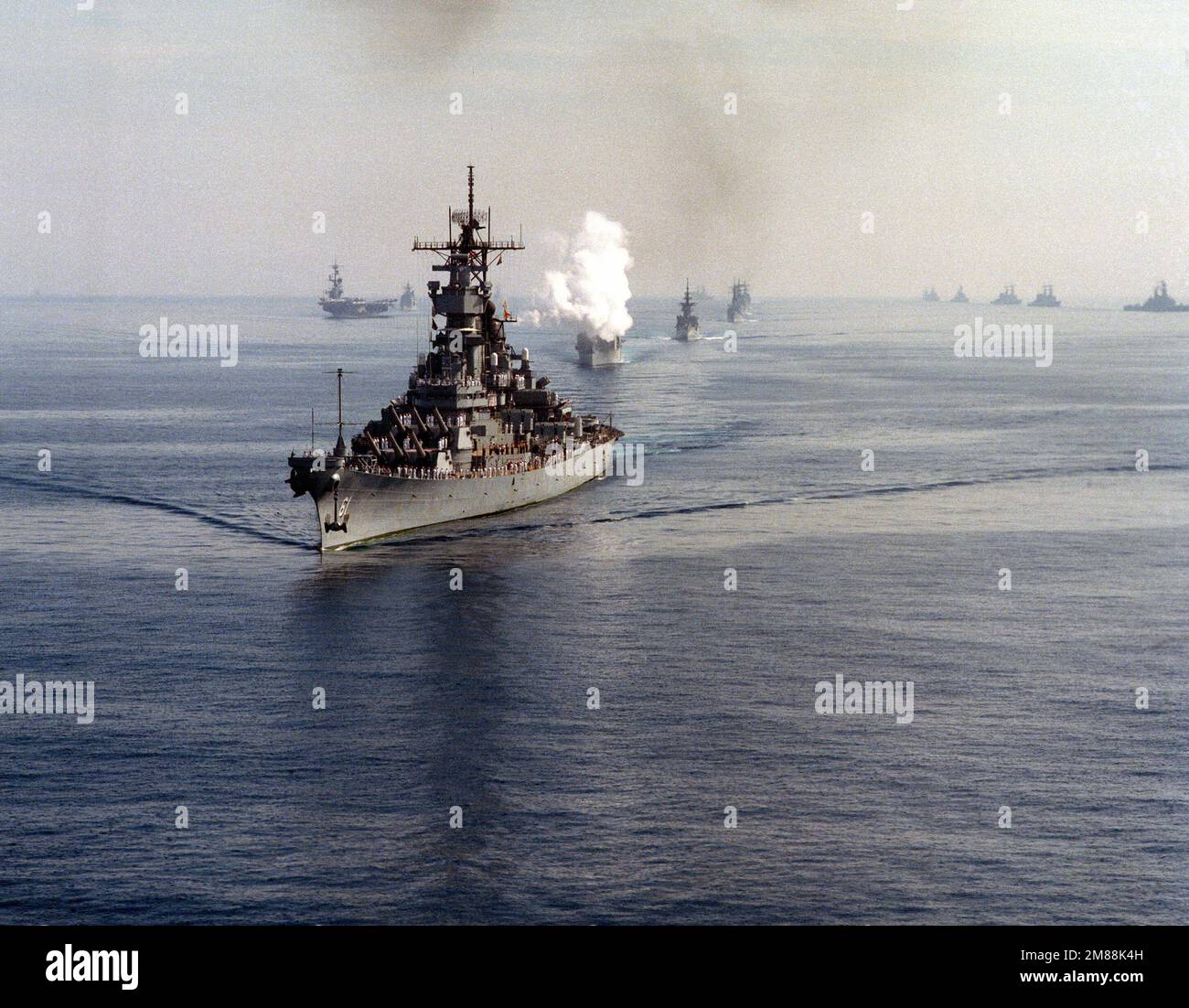 The battleship USS IOWA (BB 61) leads its battle group into the bay. The aircraft carrier USS ...