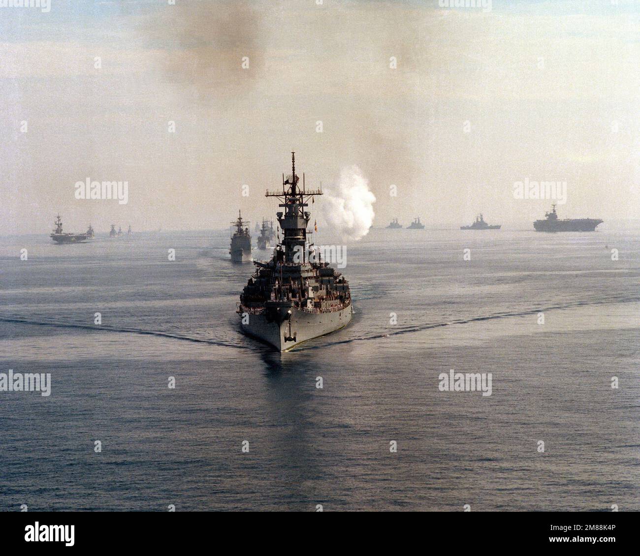 The battleship USS IOWA (BB 61) leads its battle group into the bay. The aircraft carrier USS ...