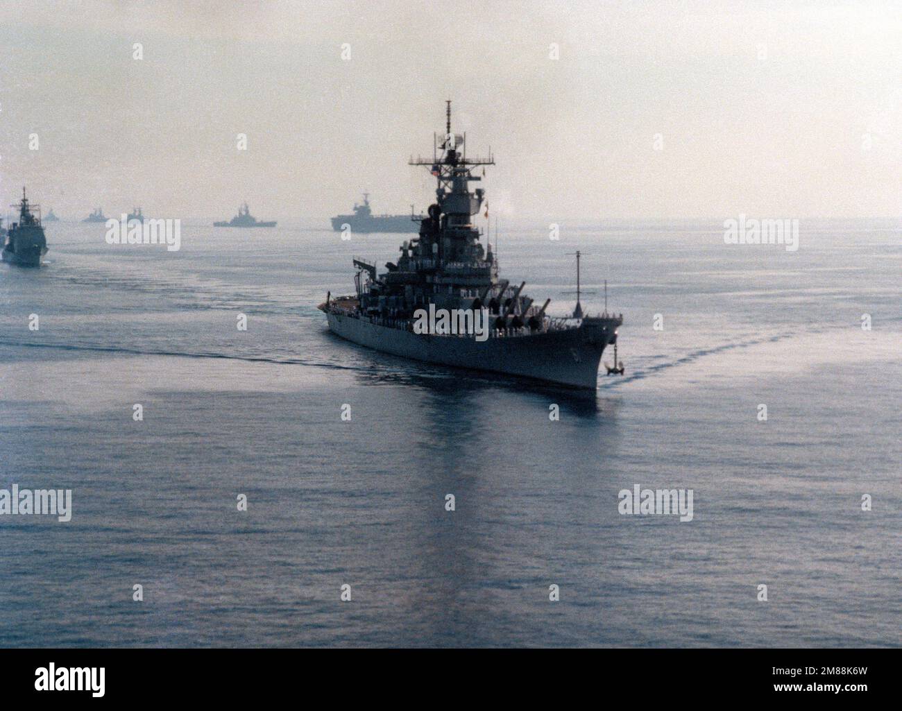 A starboard bow view of the battleship USS IOWA (BB 61) underway as it enters the bay at the ...