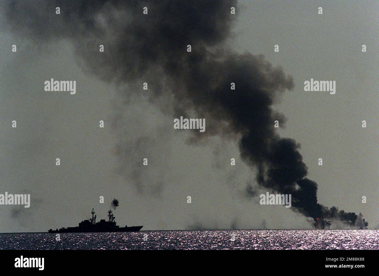 The Spruance class destroyer USS JOHN F. YOUNG (DD-973) sails by a pair ...