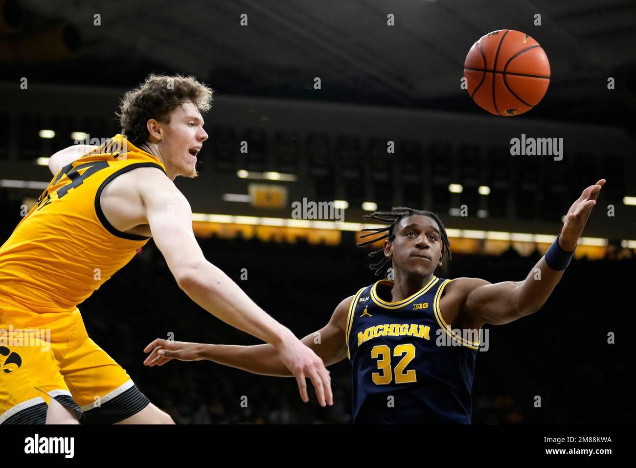 Iowa forward Riley Mulvey, left, fights for a rebound with Michigan ...