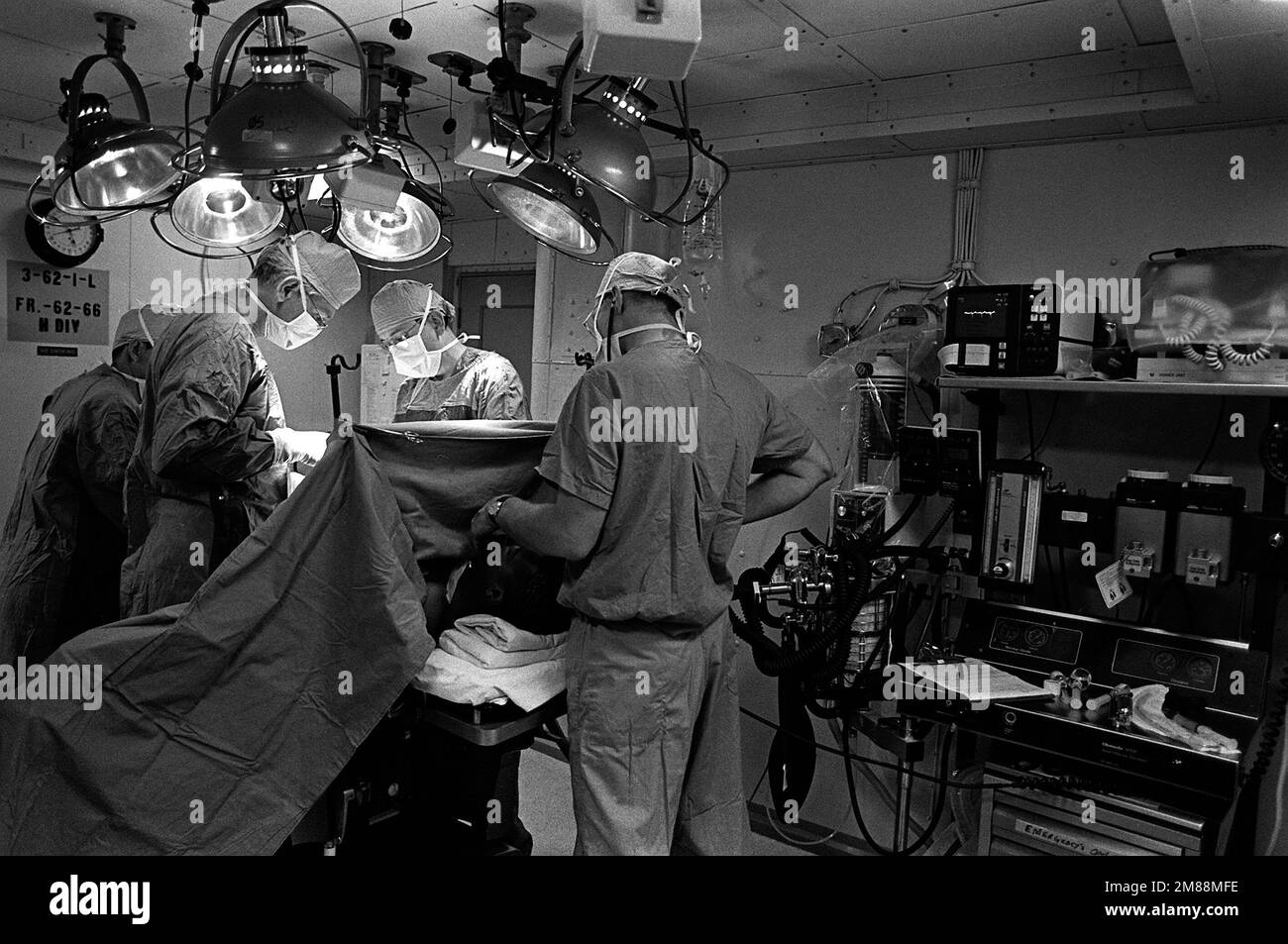 Doctors perform surgery on a patient in the operating room on board the ...