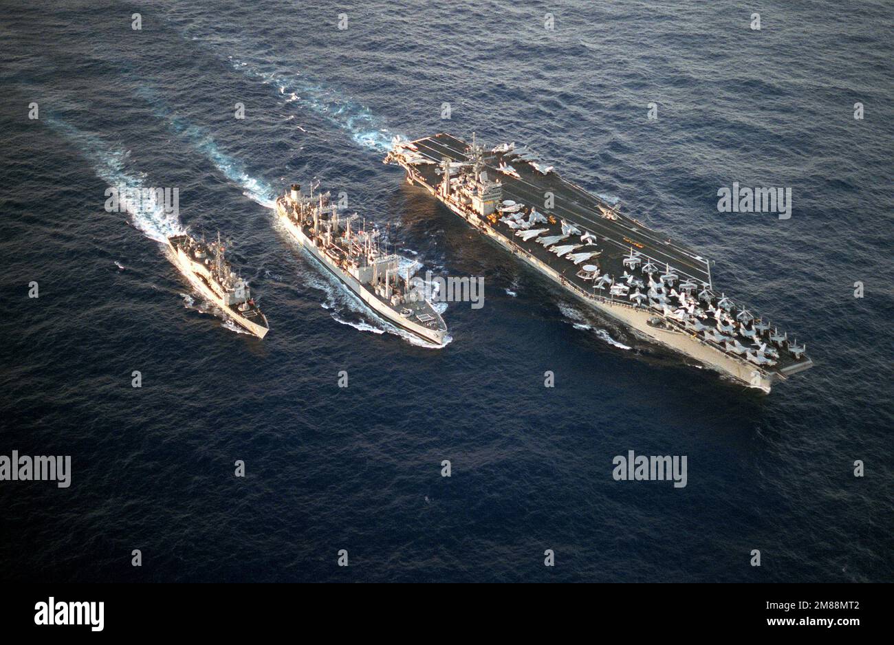 An elevated starboard bow view of the fleet oiler USS CALOOSAHATCHEE ...