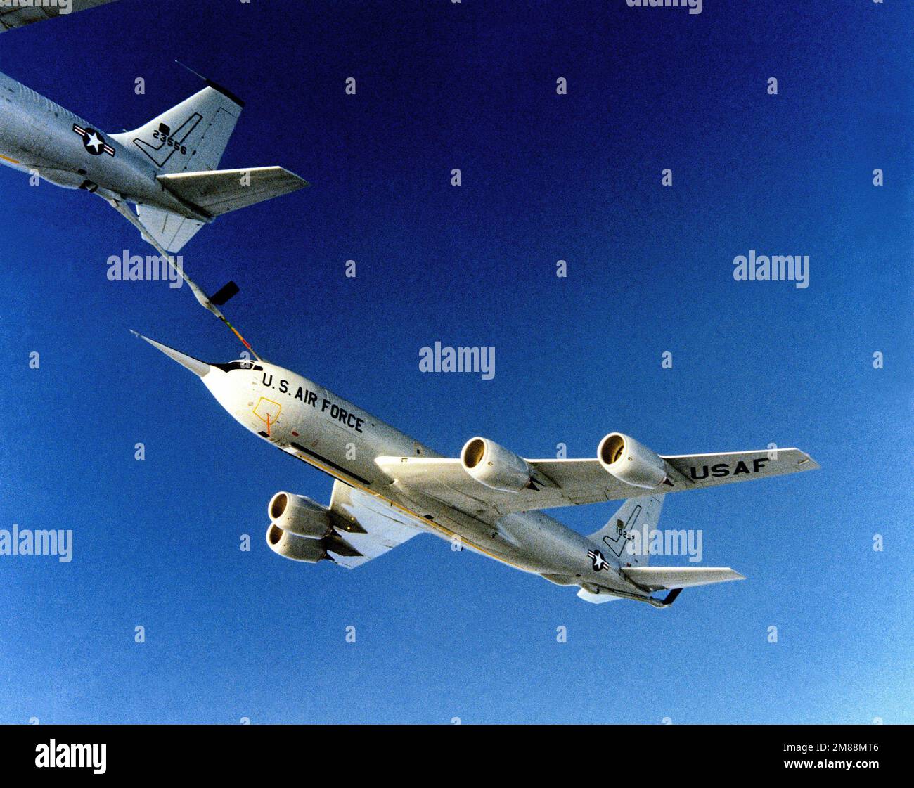 An air-to-air left side view of the refueling connection of a KC-135A ...
