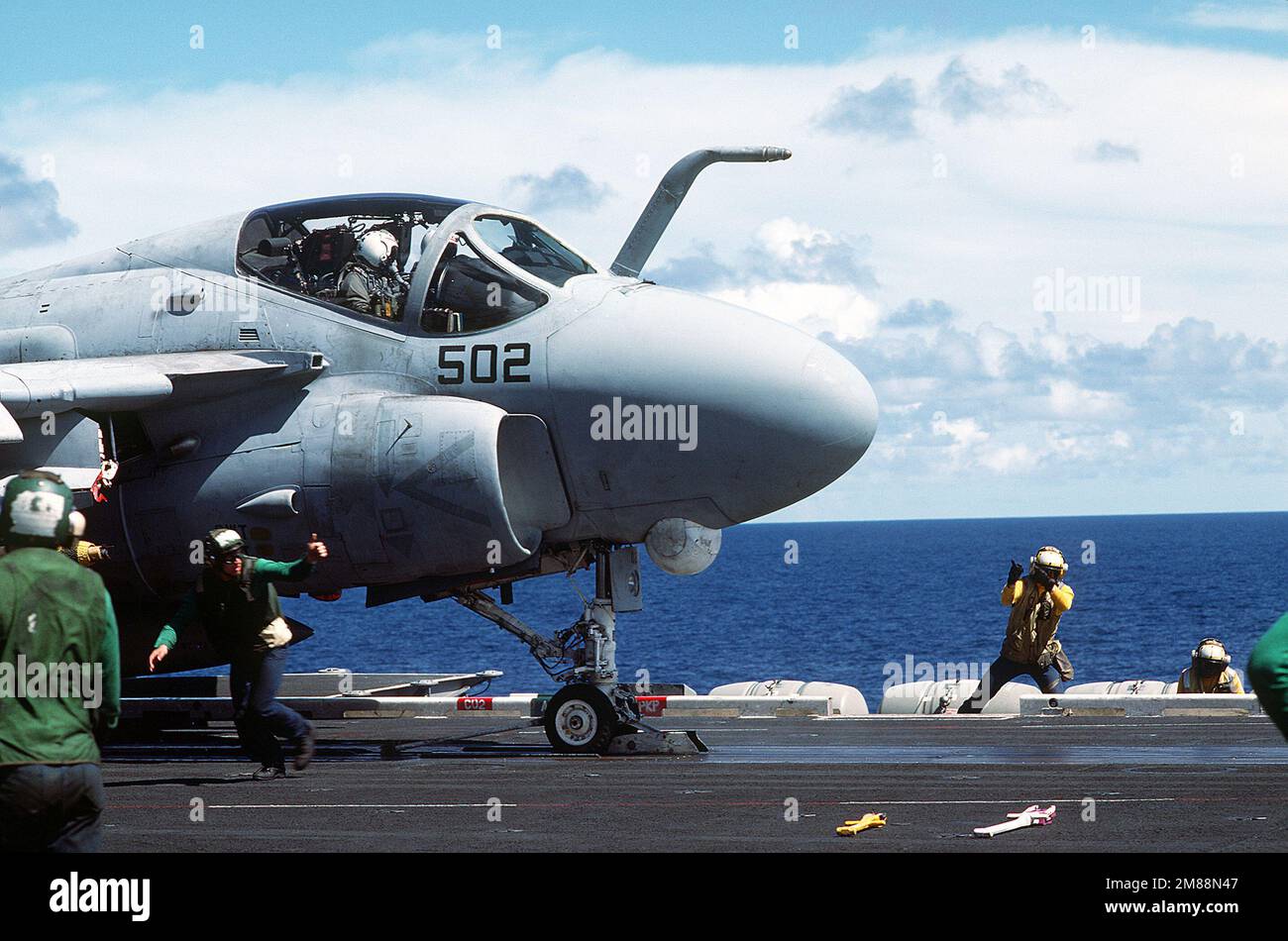 A plane director signals instructions to the pilot of an Attack ...