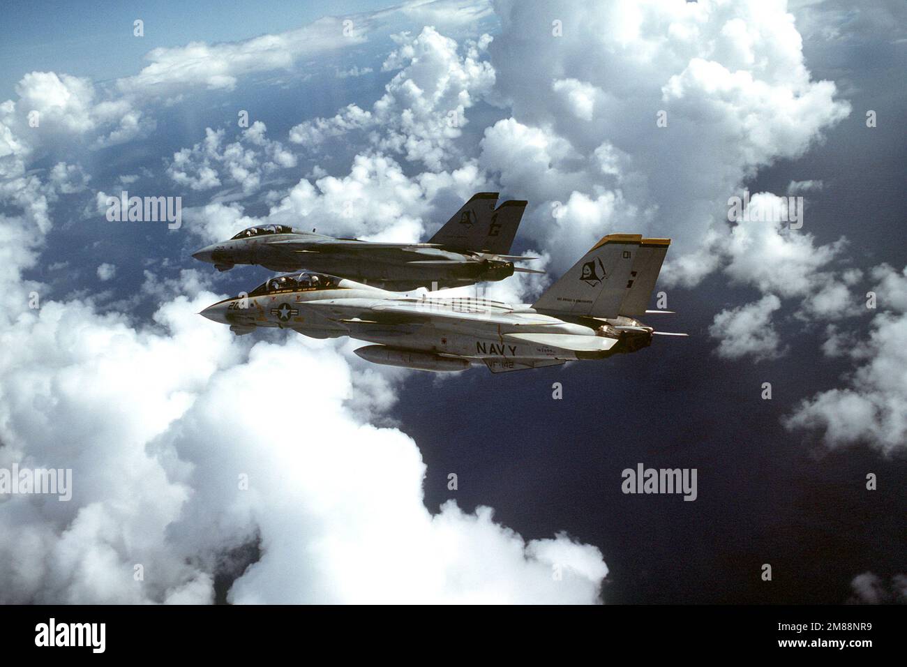 An air-to-air left side view of a pair of Fighter Squadron 142 (VF-142 ...
