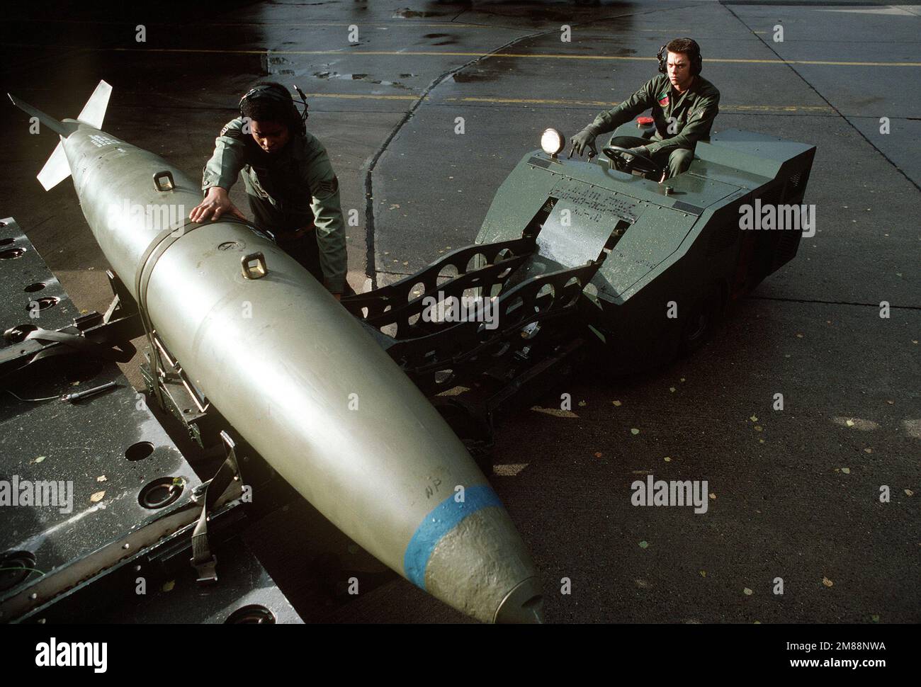 A1C William Ayers, right, stands by behind the wheel of an MJ-1B ...