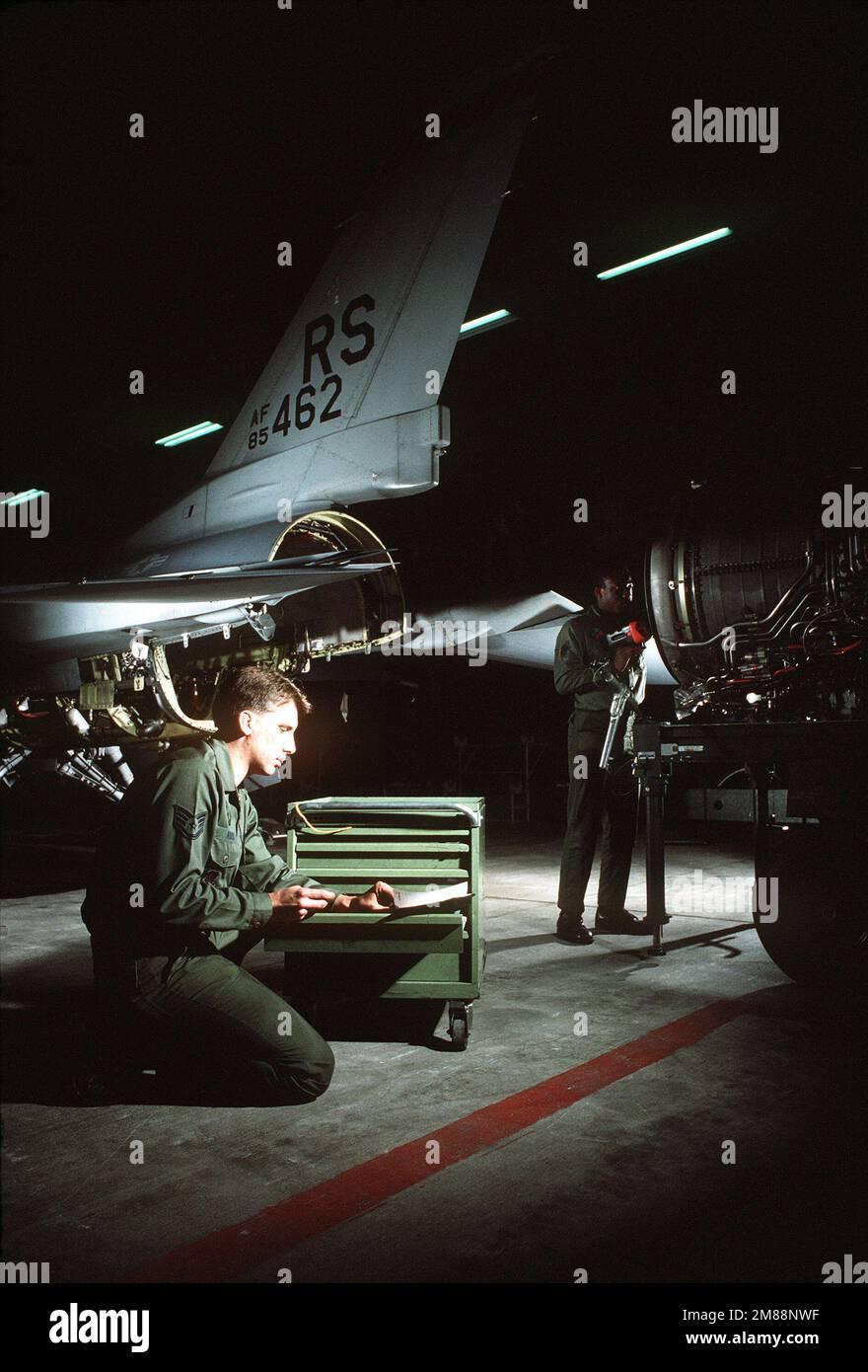 SSGT Michael Mlodzik kneels to review a technical manual as he and SGT ...