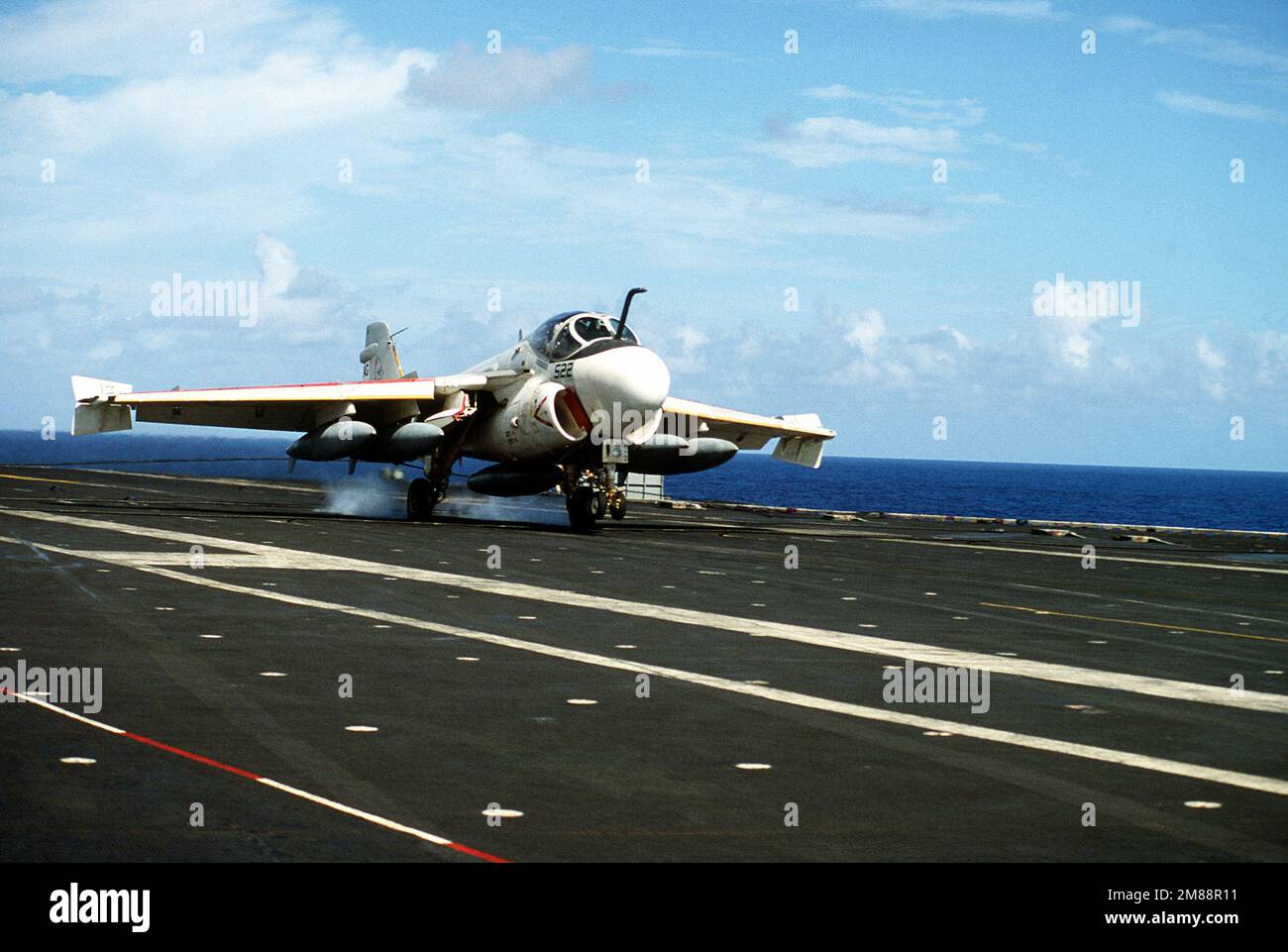 An A-6 Intruder aircraft engages an arresting cable after landing ...
