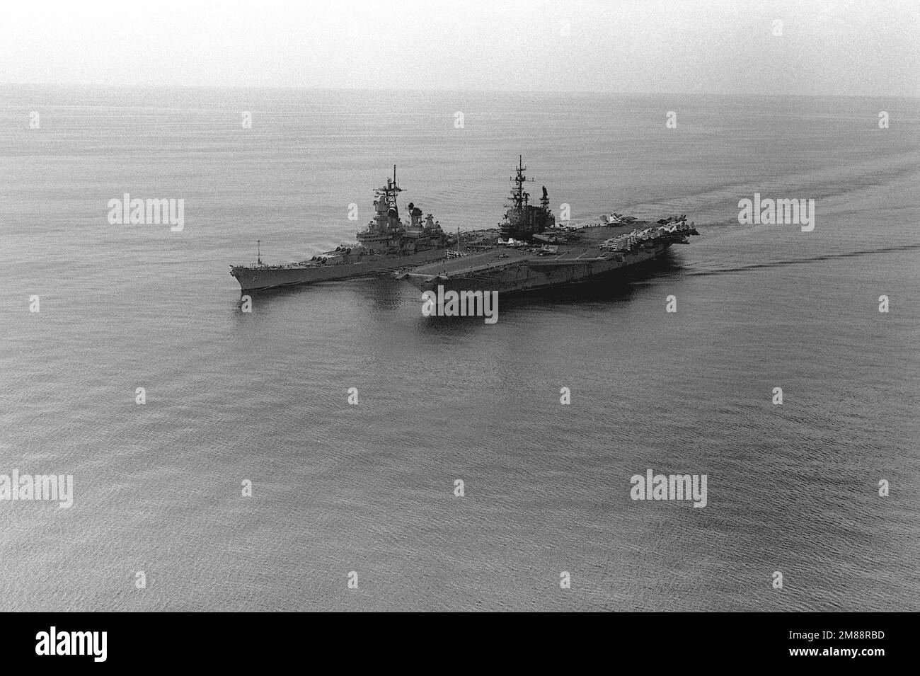 A port bow view of the battleship USS IOWA (BB-61) and the aiarcraft carrier USS MIDWAY (CV-41 ...