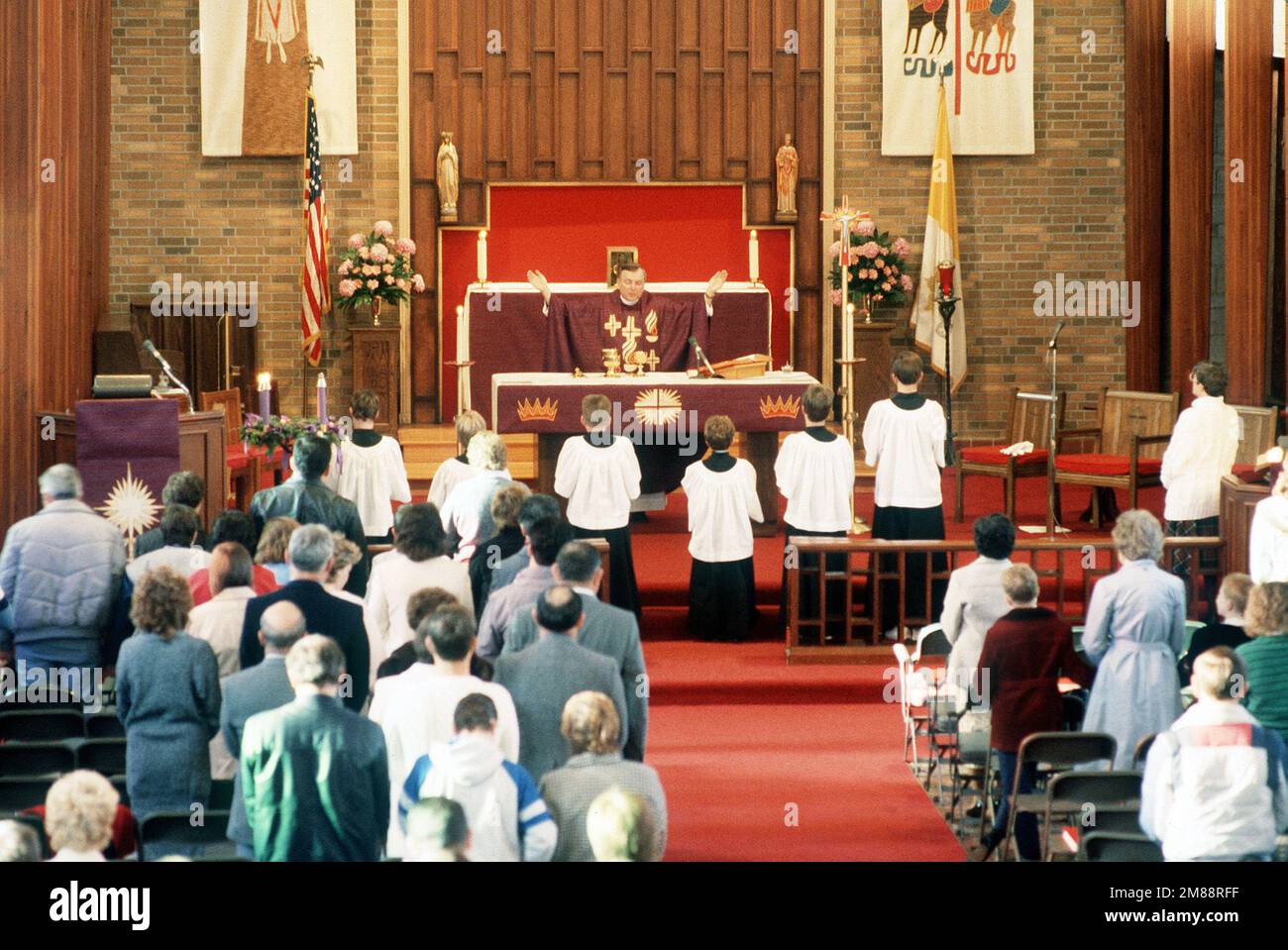 Chaplain (CMDR.) Robert Kincl prepares the eucharistic gifts during ...