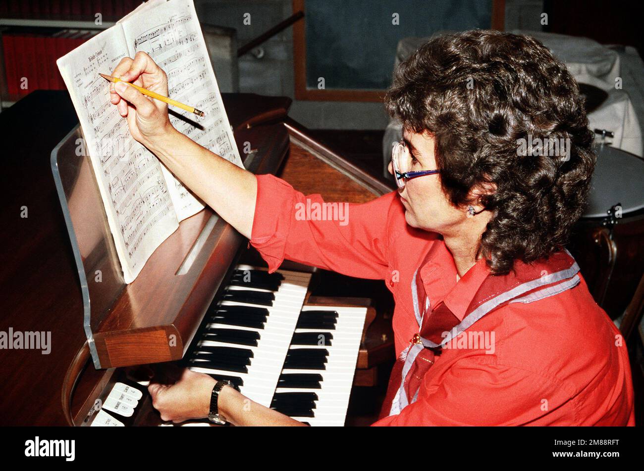 Protestant choir director and organist Karen Walters annotates a score ...