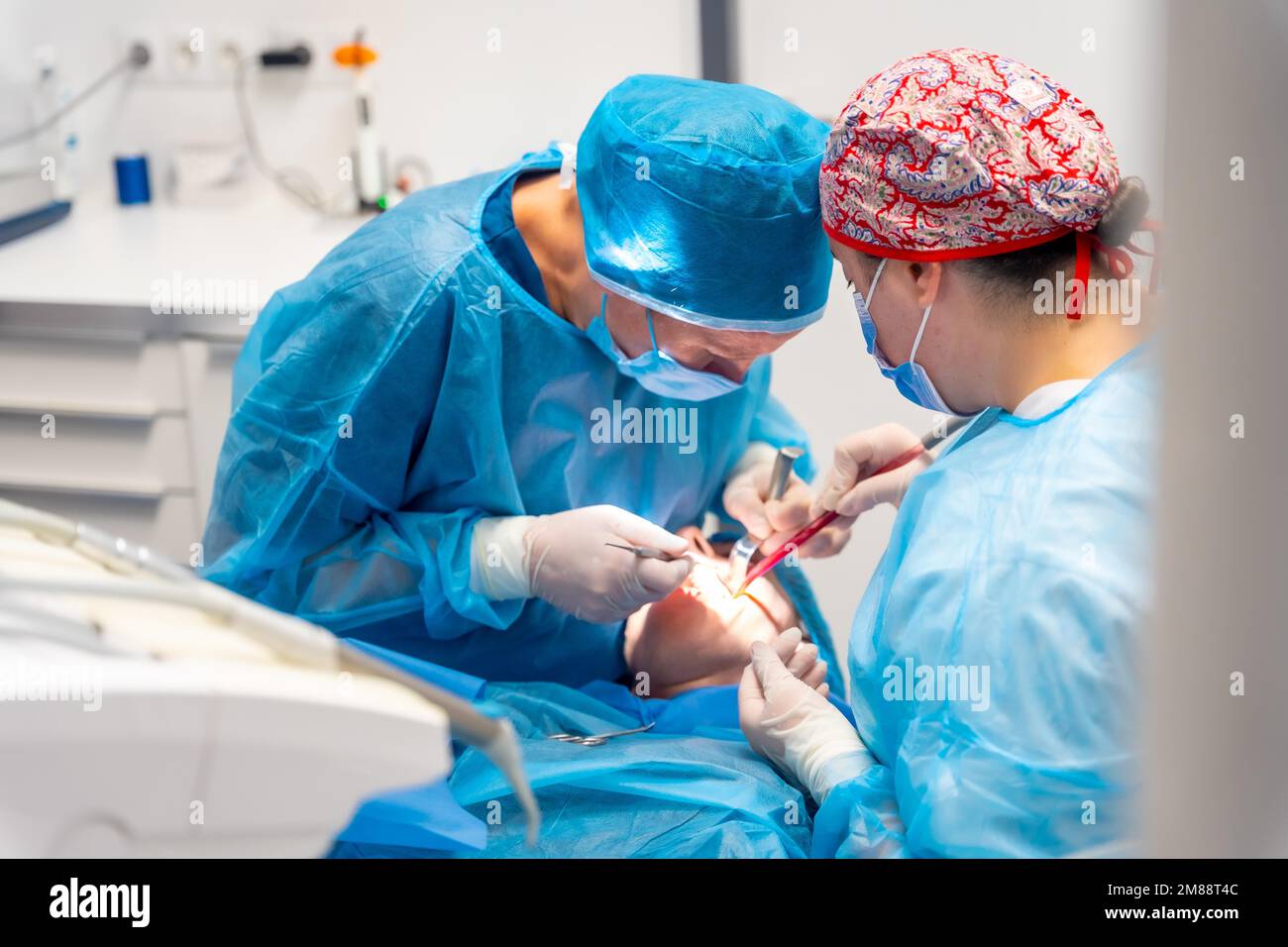 Dental clinic, dentist doctor and the assistant performing an oral ...