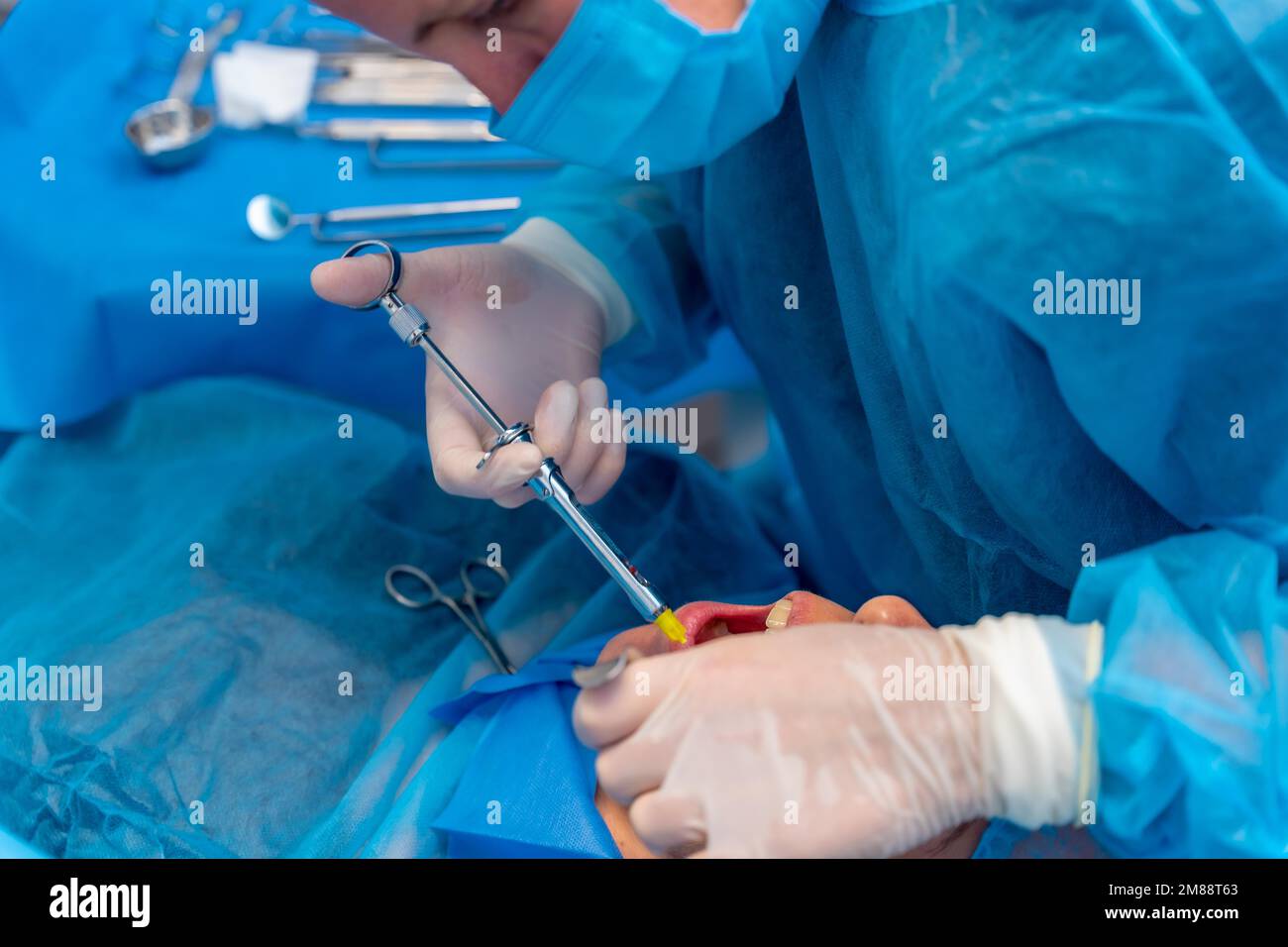 Dental clinic, dentist doctor applying an anesthetic injection to the ...
