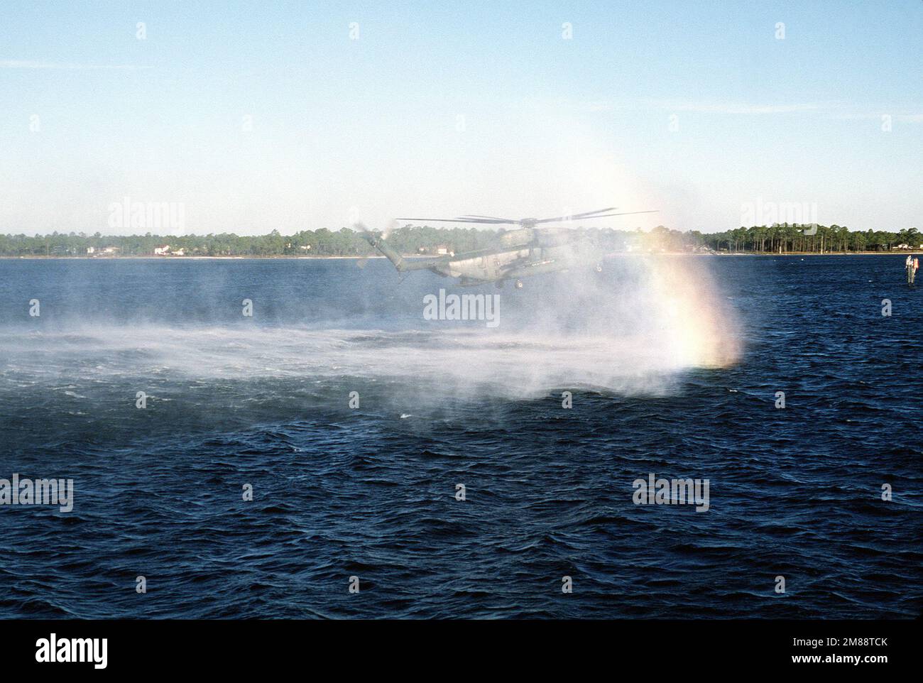 A rainbow is formed as an MH-53H helicopter of the 1ST Special ...
