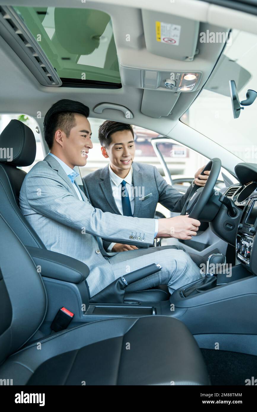 Young people in the car 4 s shop Stock Photo - Alamy