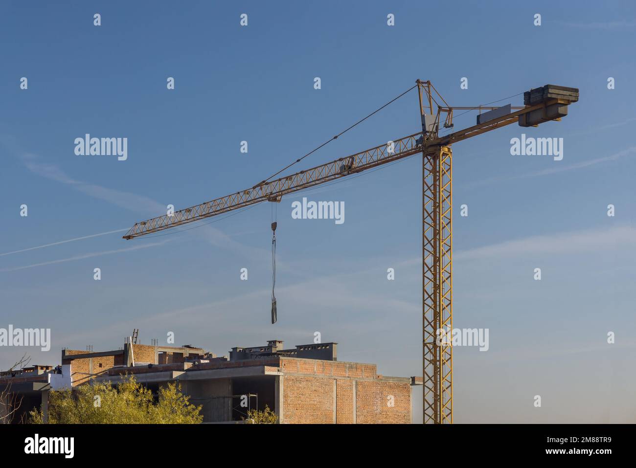 Multi storey apartment building is being constructed using tower cranes ...