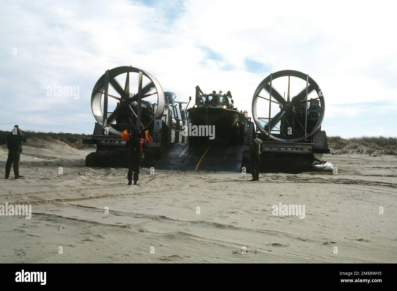 A LARC-5 amphibious cargo carrier is unloaded from an air cushion ...