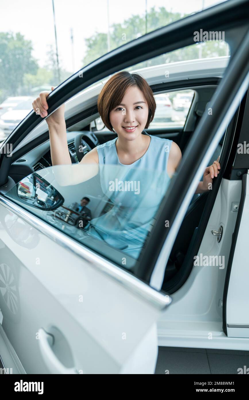 Young people in the car 4 s shop Stock Photo - Alamy