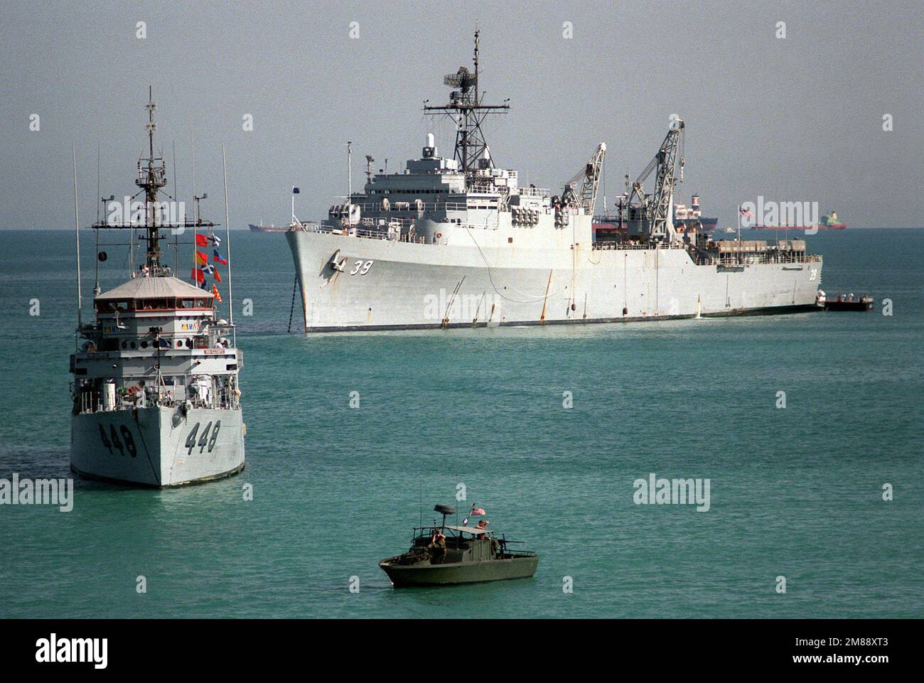 A bow view of the ocean minesweeper USS ILLUSIVE (MSO-448) with the ...
