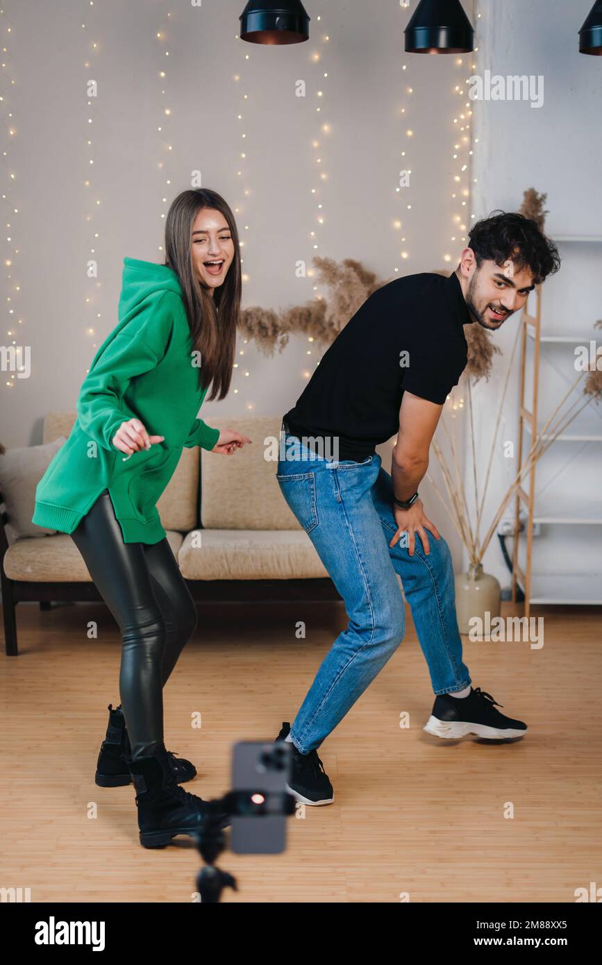 Funny man and woman recording video for social media dancing in front ...