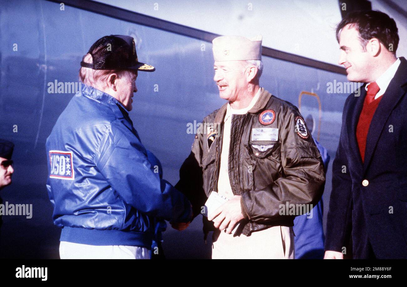 Captain J. Monroe Smith, commanding officer of the station, greets ...