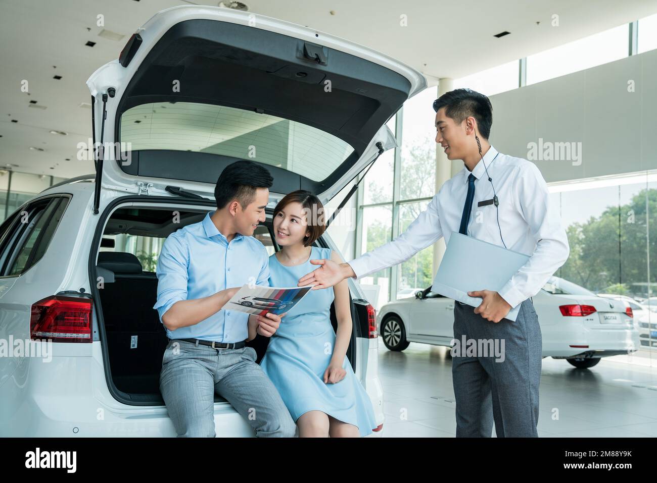Young people in the car 4 s shop Stock Photo - Alamy