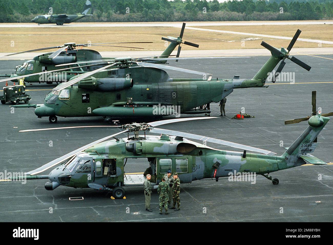 A left side view of an MH-53H Pave Low helicopter, background, an MH ...