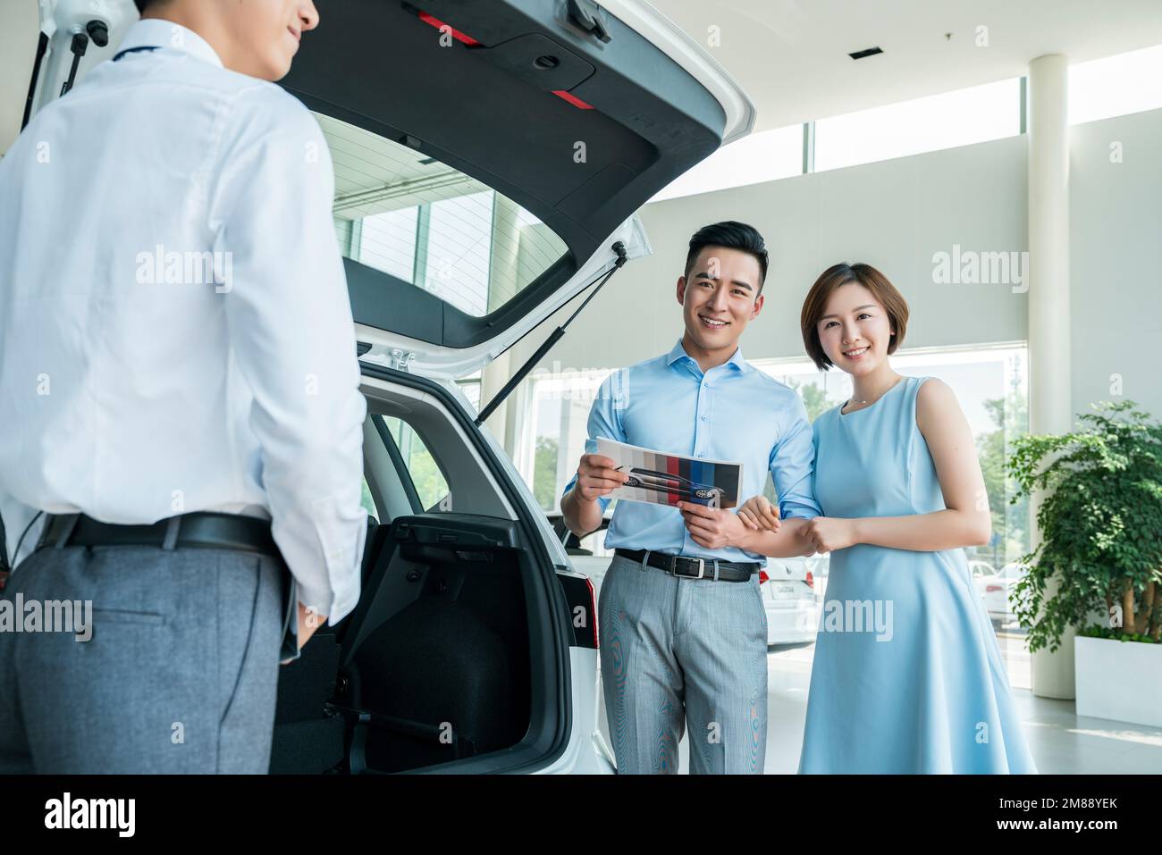 Young people in the car 4 s shop Stock Photo - Alamy