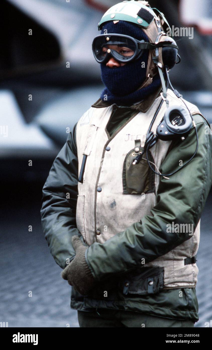 A flight deck crewman aboard the nuclear-powered aircraft carrier USS ...