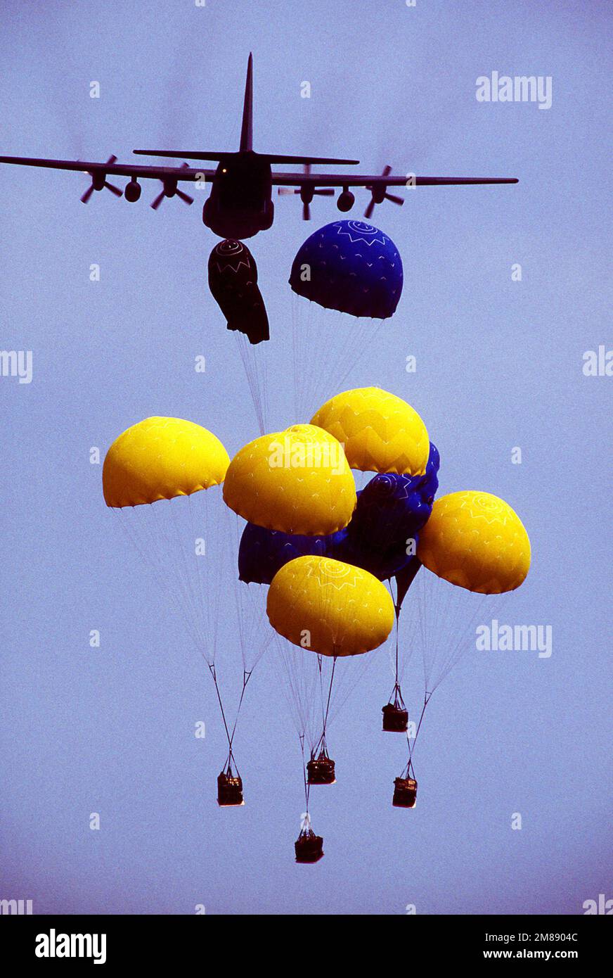 A 37th Tactical Airlift Squadron C-130E Hercules aircraft airdrops ...