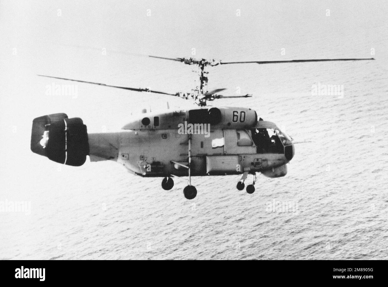 An air-to-air right side view of a Soviet navy Ka-27 Helix A helicopter ...